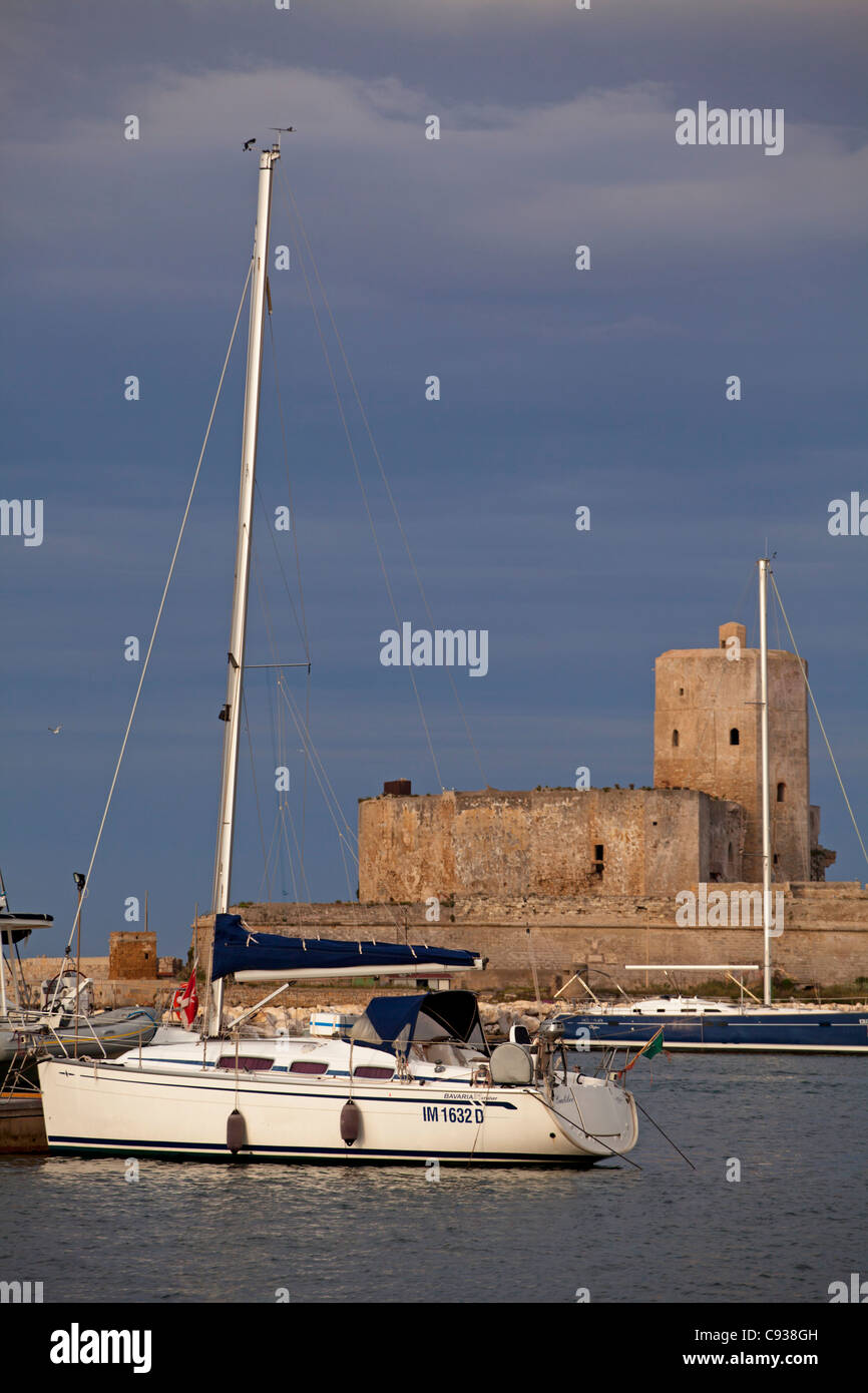 Sicily, Italy, Western Europe; A yacht in the port of Trapani with the ...