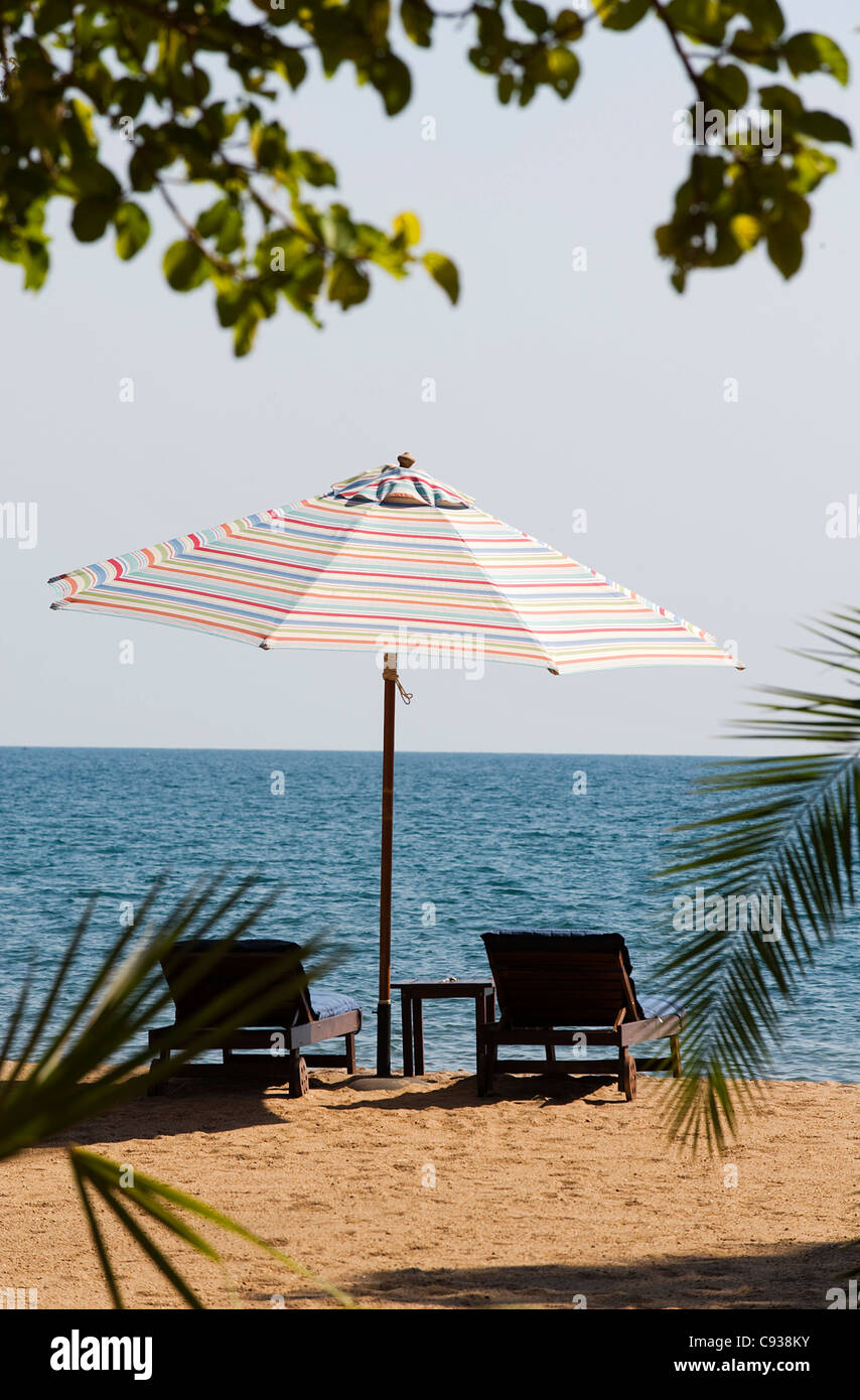 Malawi, Lake Malawi National Park. Sun loungers and large umbrella on ...