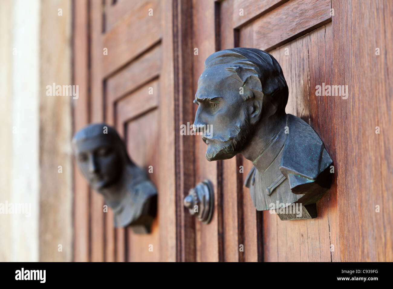Poland, Cracow. Figureheads of famous Poles on the main entrance door ...