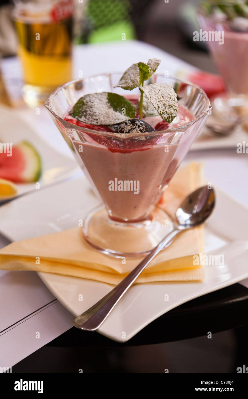 Poland, Cracow. A raspberry and plum milkshake decorated with mint at ...