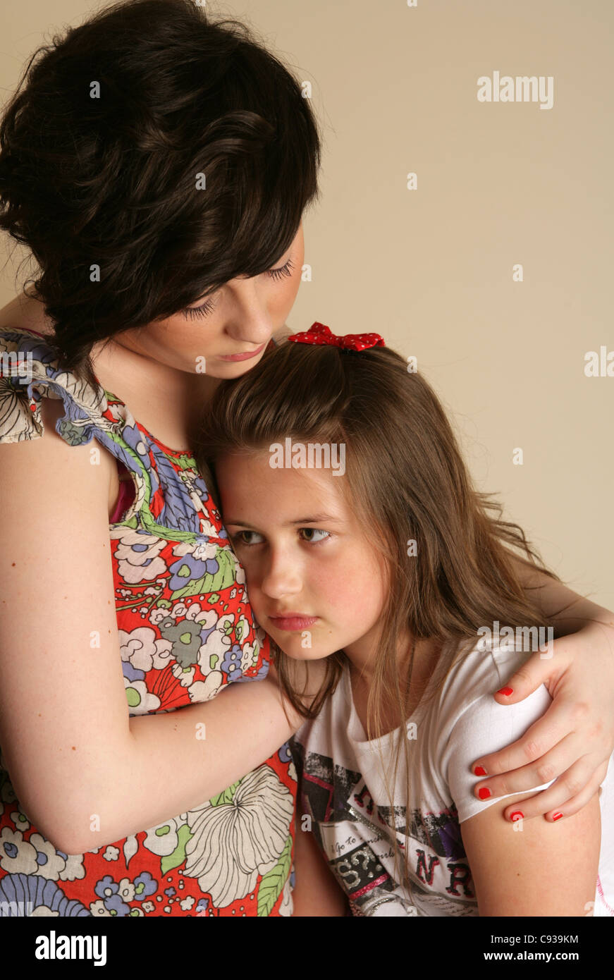Elder sister comforting her younger sister Stock Photo - Alamy