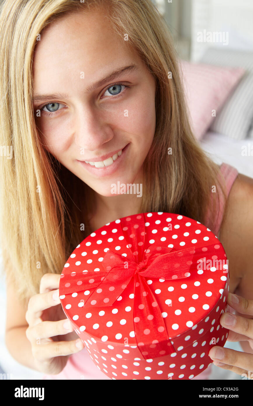 Teenage girl holding gift box Stock Photo - Alamy