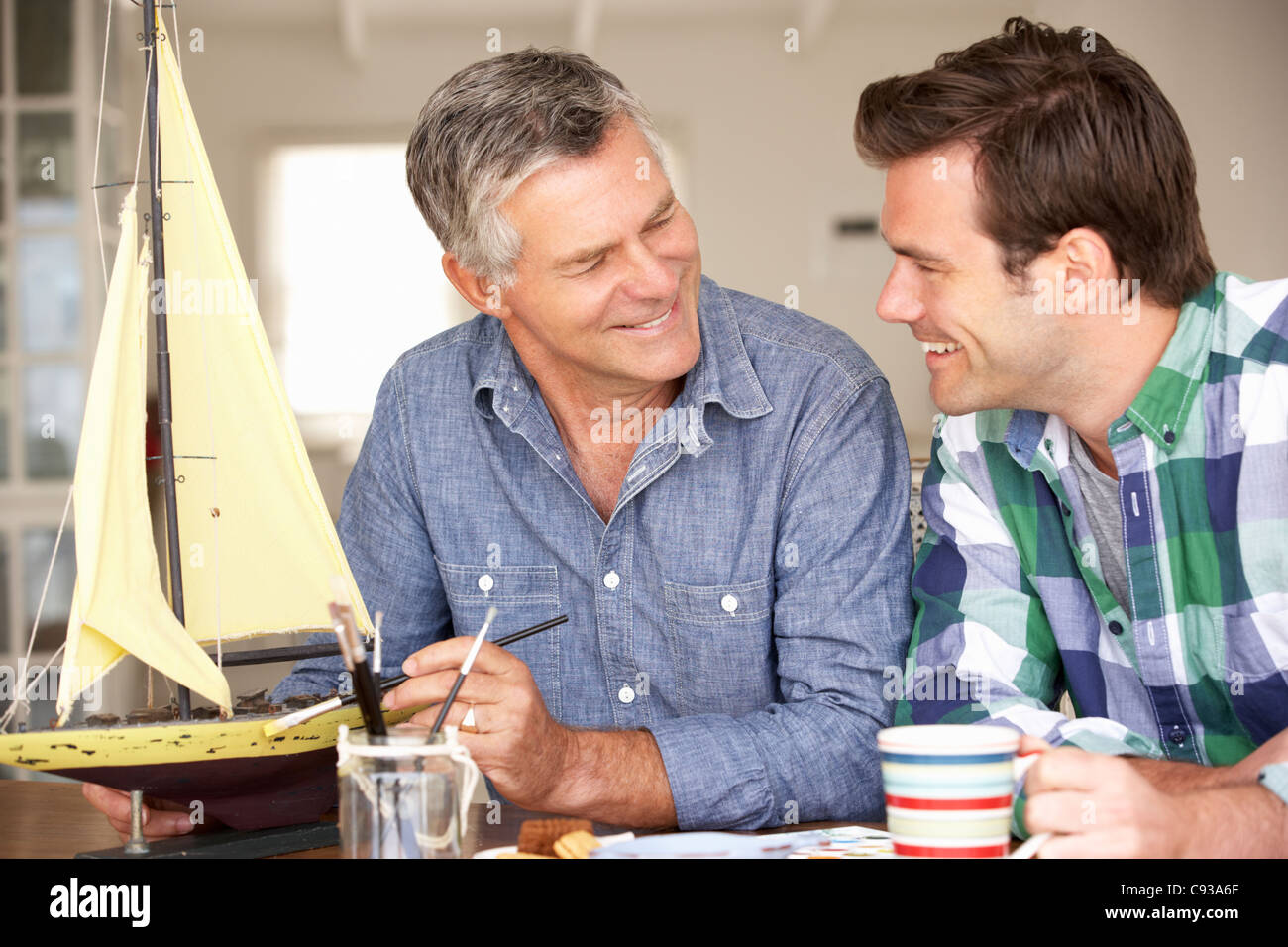 Adult father and son model making Stock Photo - Alamy