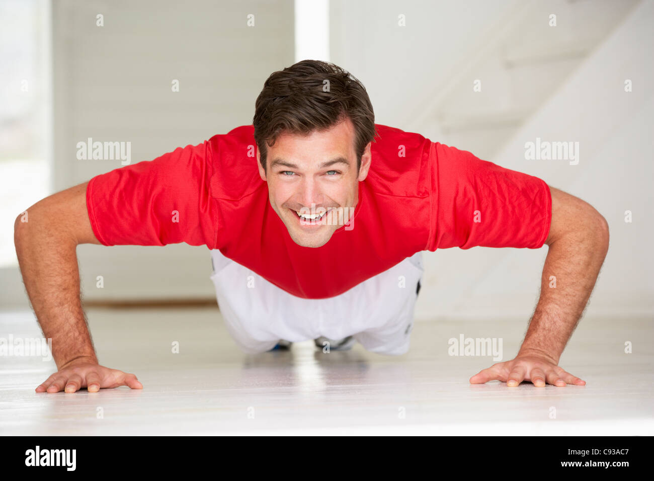 Man doing push-ups in home gym Stock Photo - Alamy