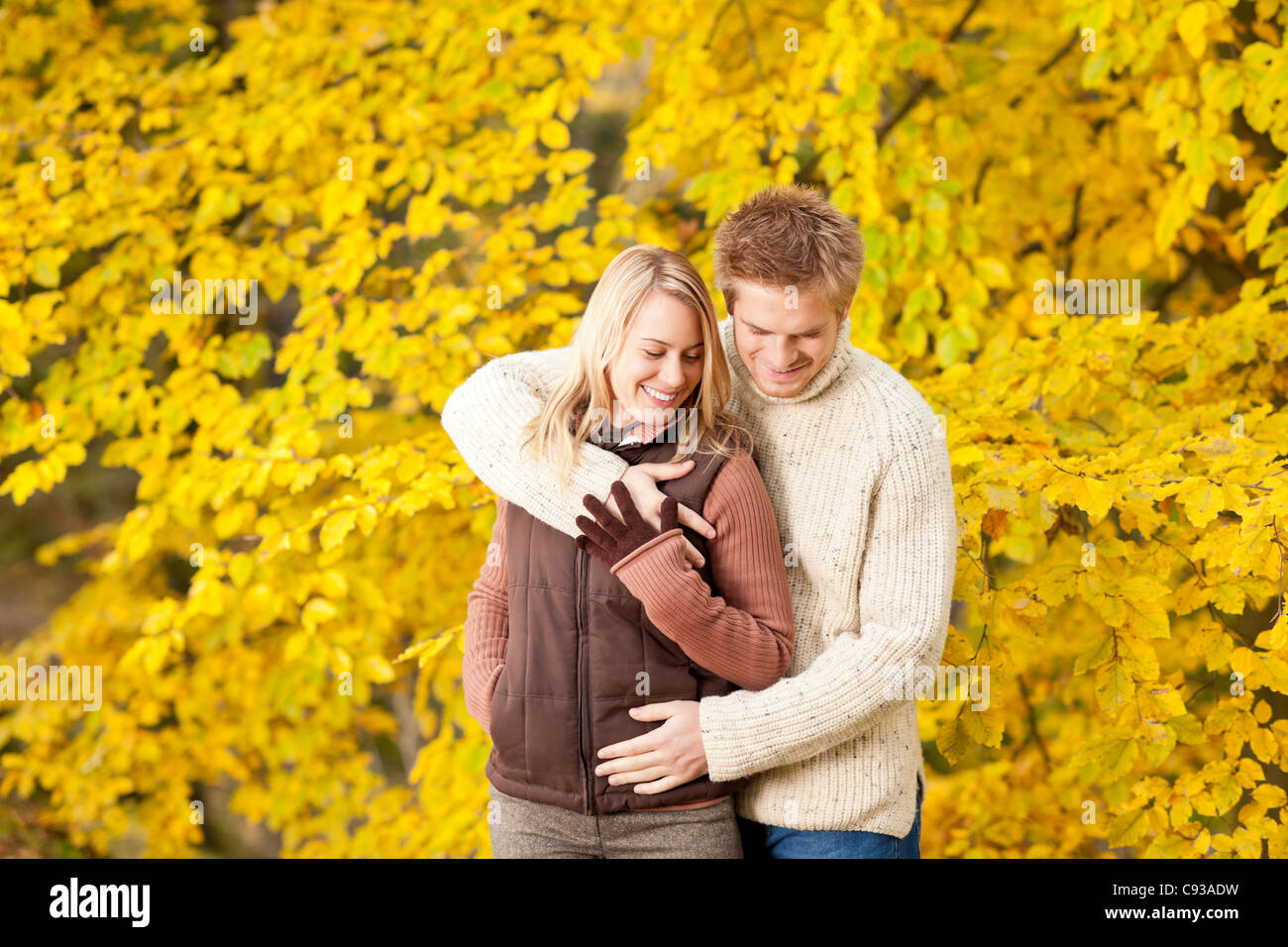 Autumn smiling young couple in love hugging in park together Stock ...