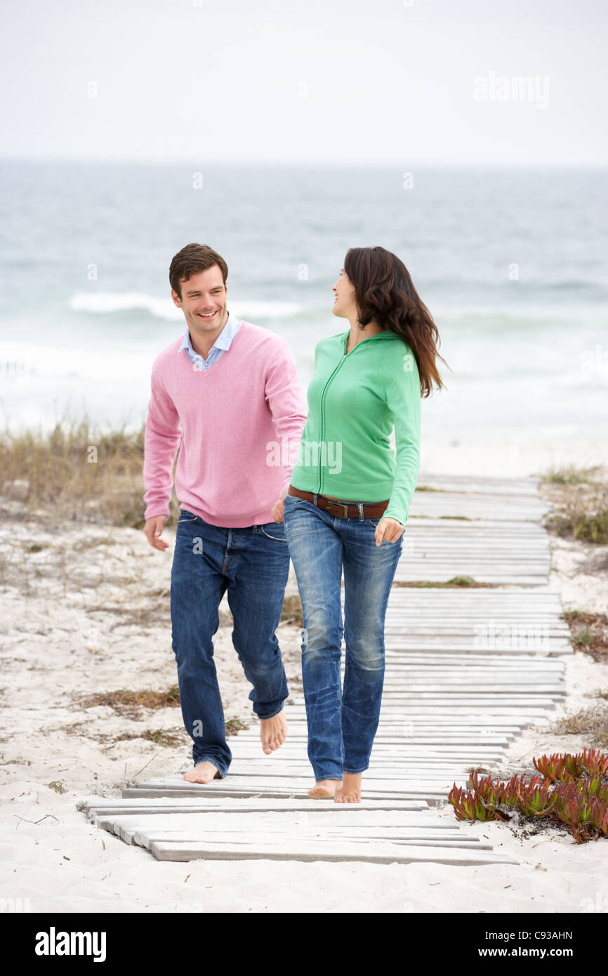 Couple running along beach path Stock Photo - Alamy