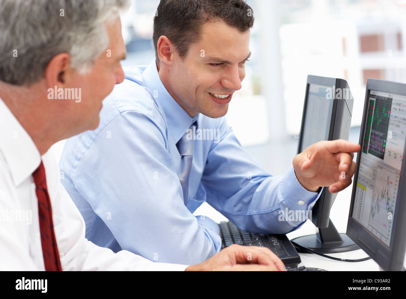 Businessmen working on computers Stock Photo - Alamy