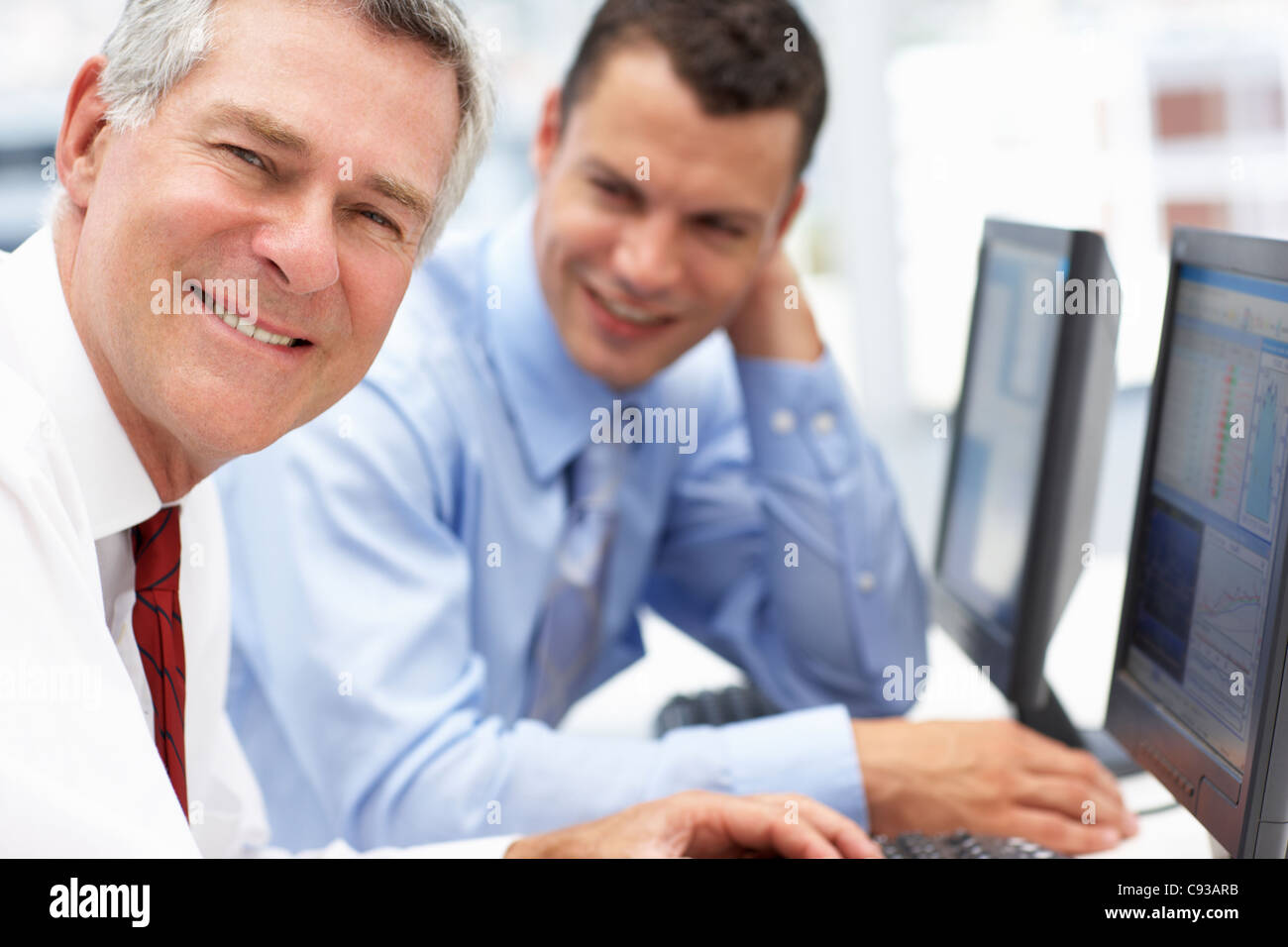 Businessmen working on computers Stock Photo - Alamy