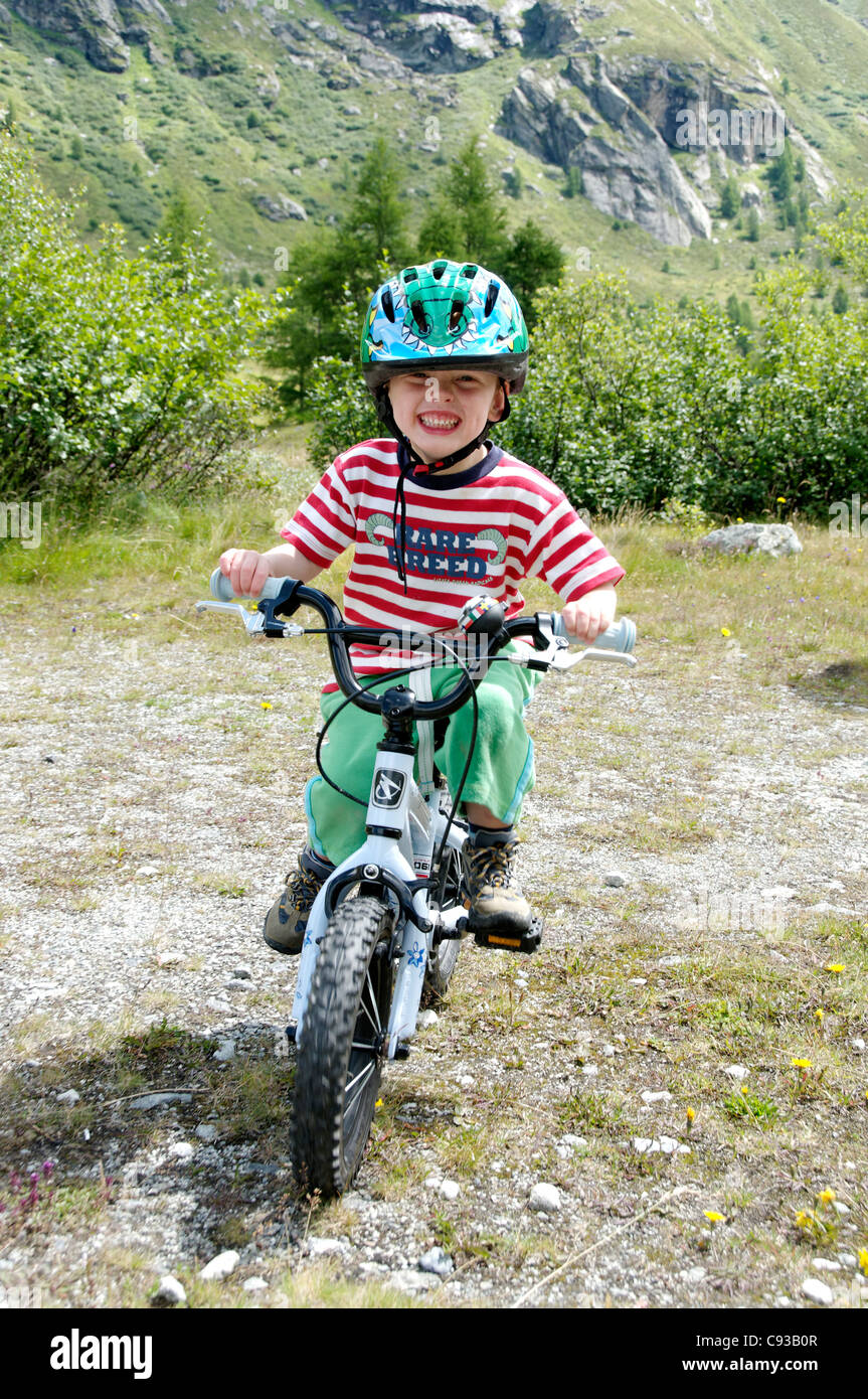 A young boy riding a bike Stock Photo - Alamy