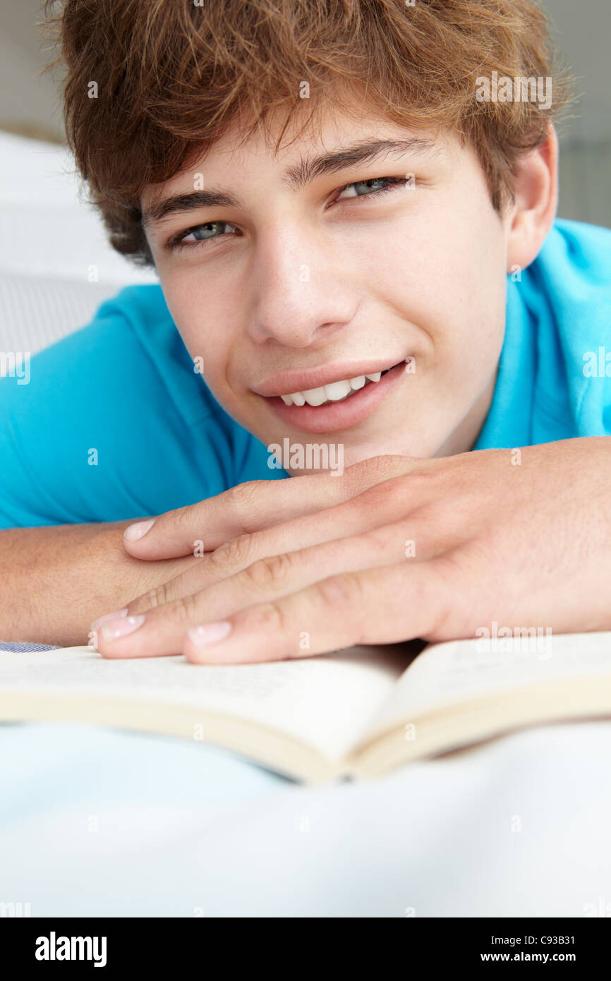 Teenage boy reading a book Stock Photo - Alamy