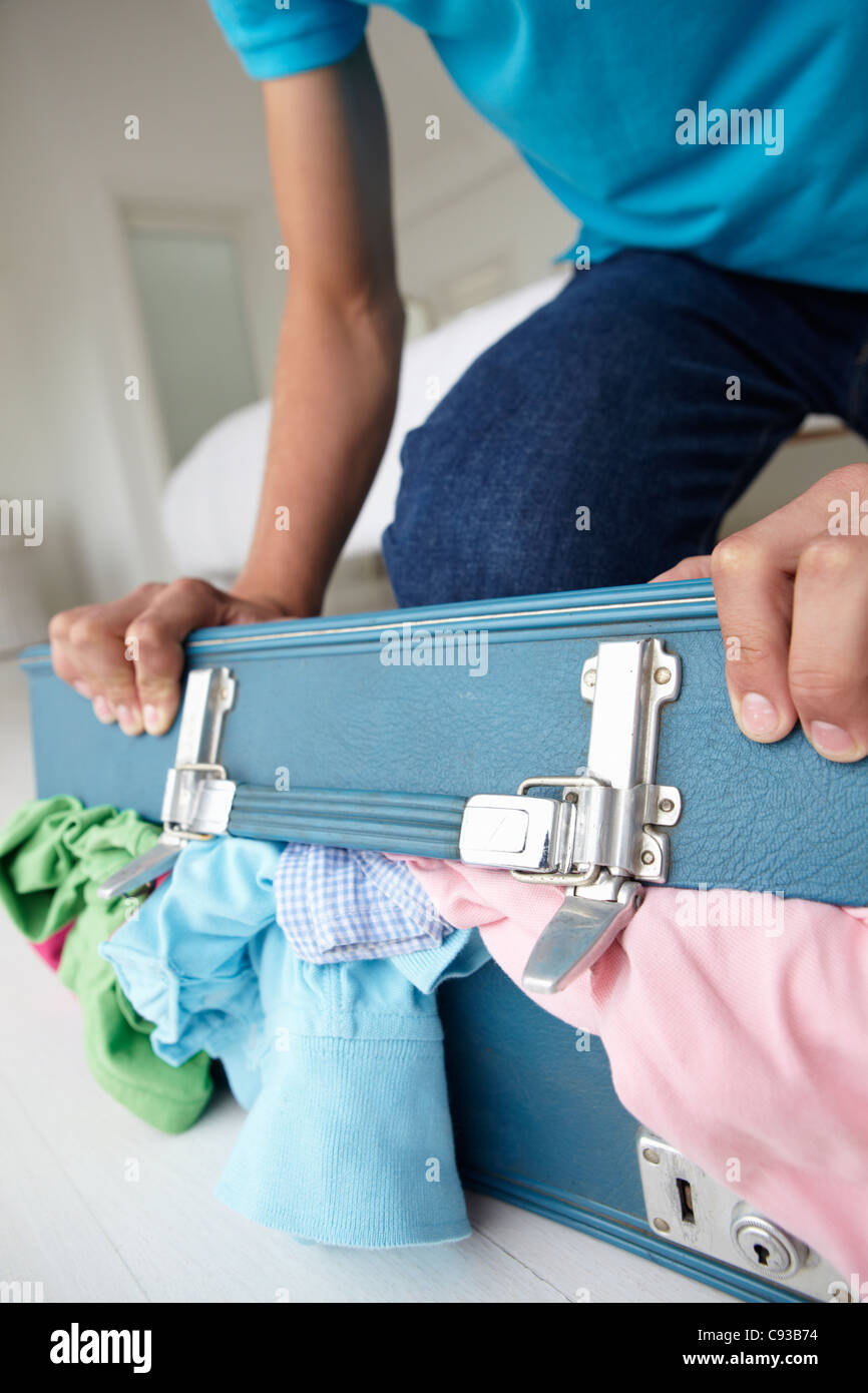 Teen boy packing suitcase hi-res stock photography and images - Alamy