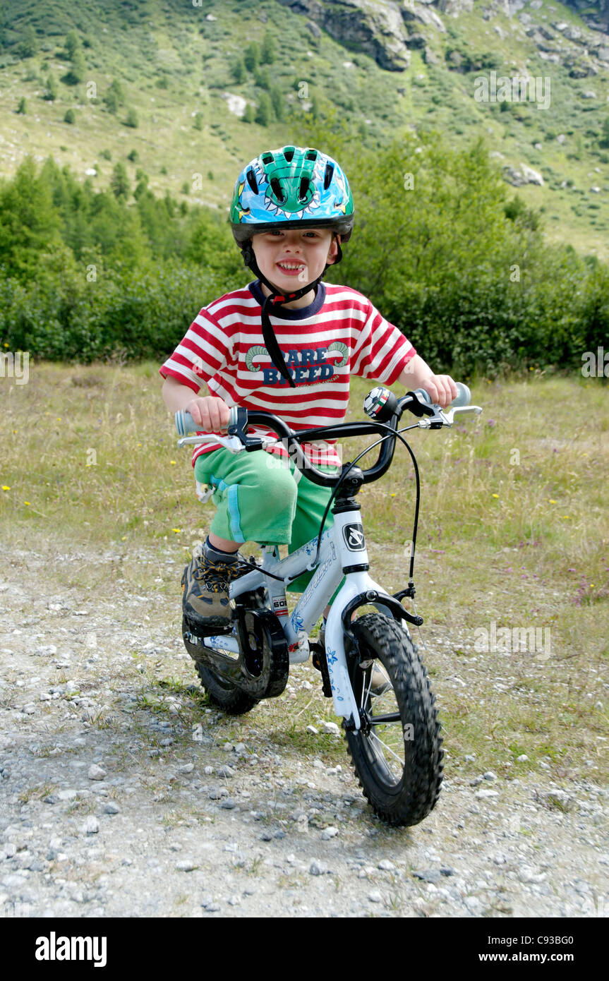 A young boy riding a bike Stock Photo - Alamy