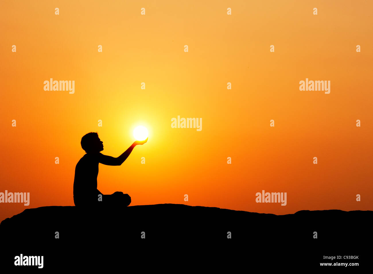 Indian man holding the sun. Silhouette. India Stock Photo - Alamy