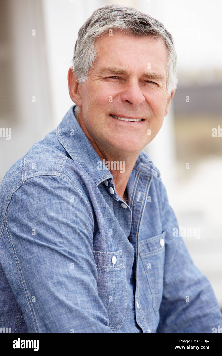 Senior man sitting outdoors Stock Photo - Alamy