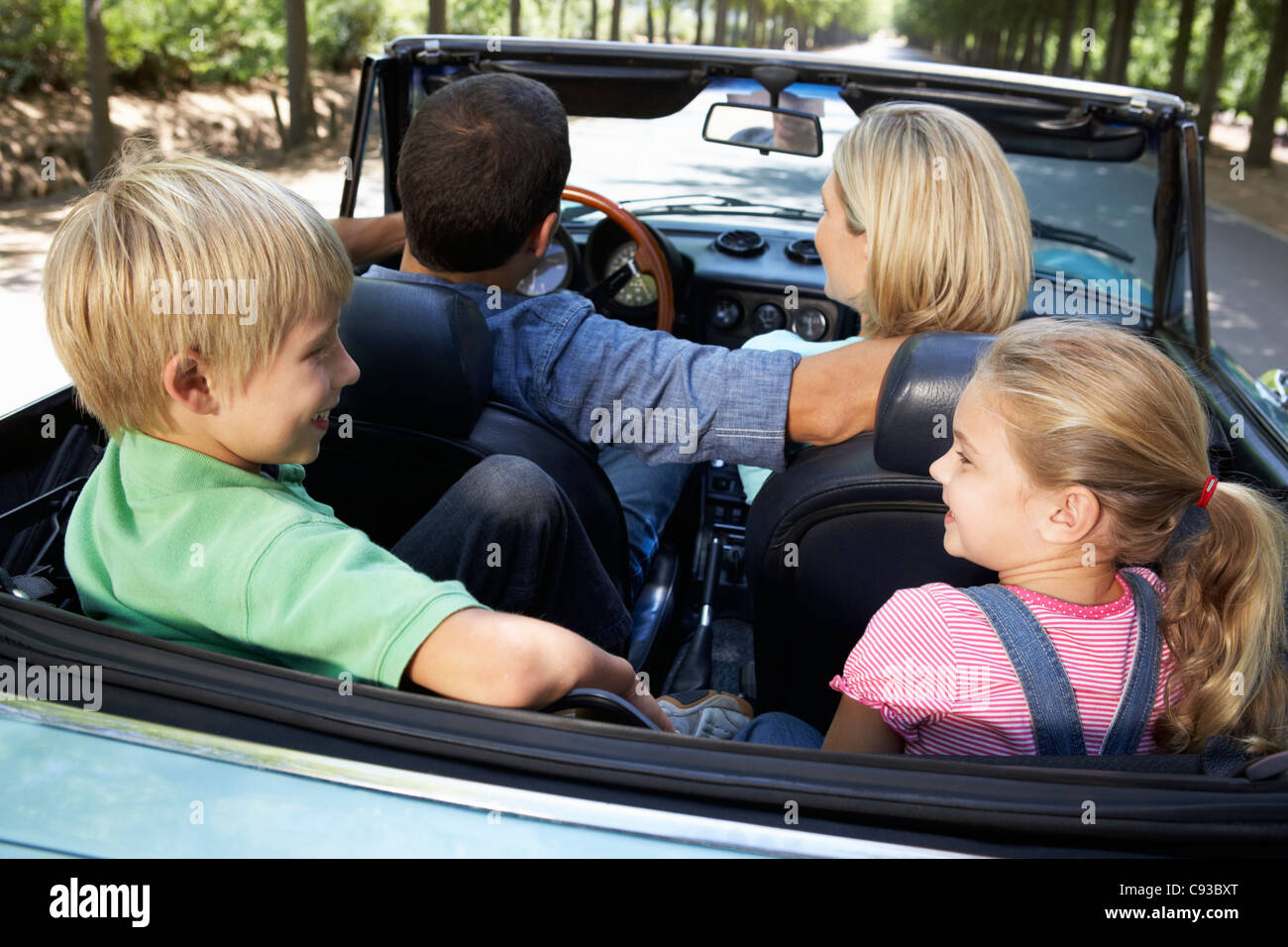 family in sports car Stock Photo - Alamy