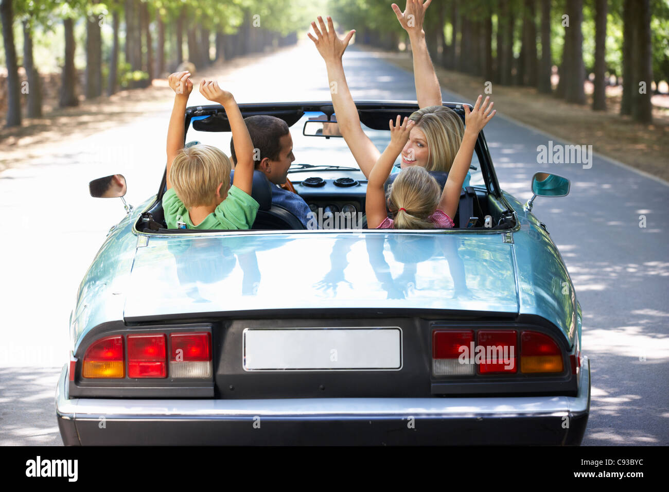 family in sports car Stock Photo - Alamy