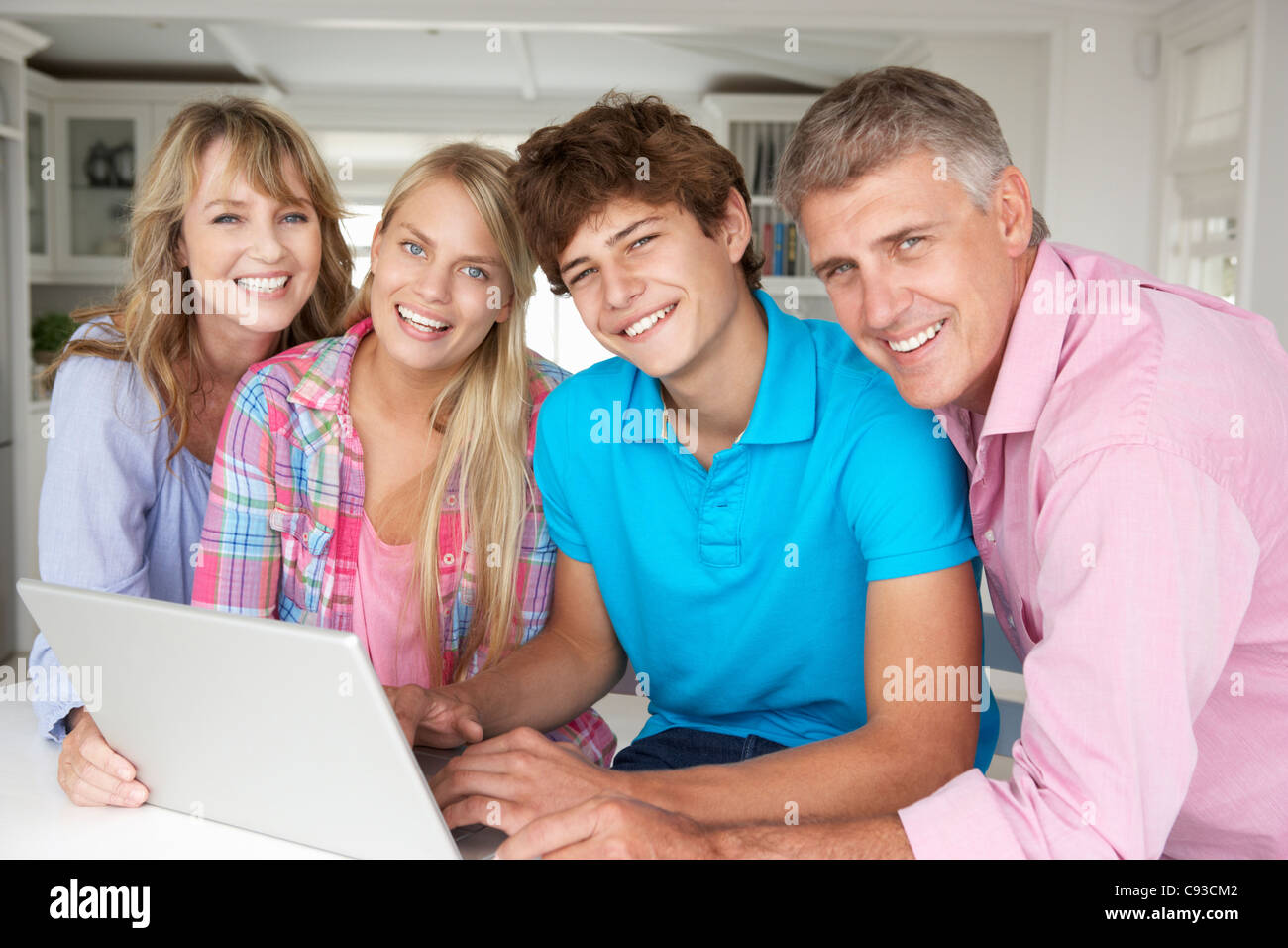 Family using laptop Stock Photo - Alamy