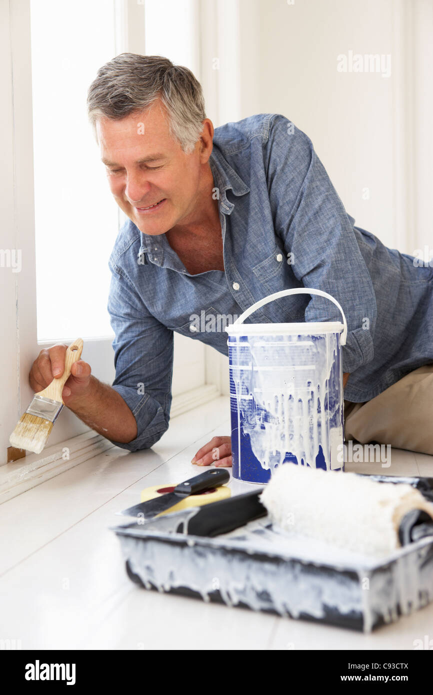 Senior man decorating house Stock Photo - Alamy