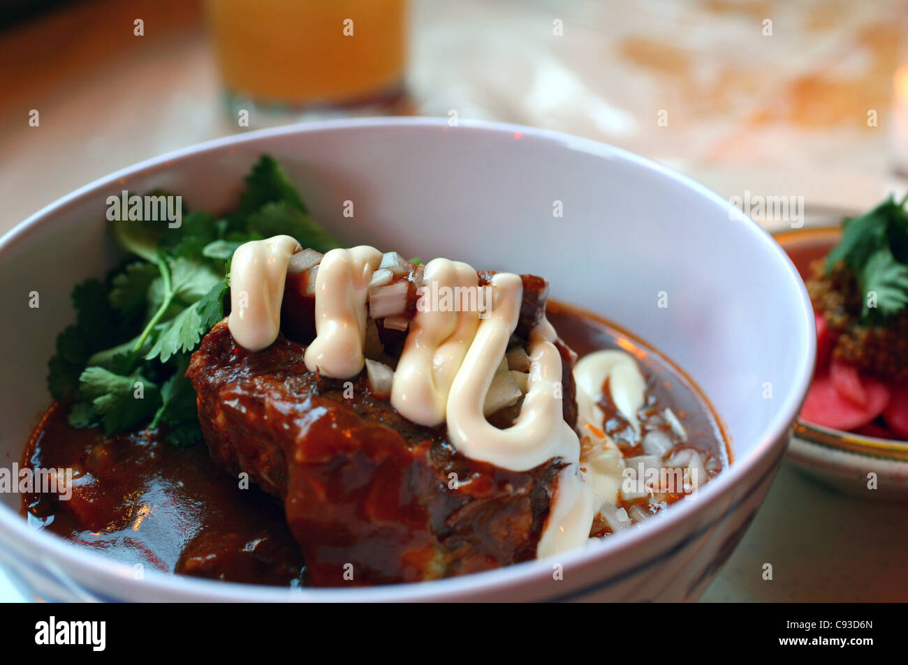 Red chili short ribs braised in chili rojo, garnished with cilantro and ...