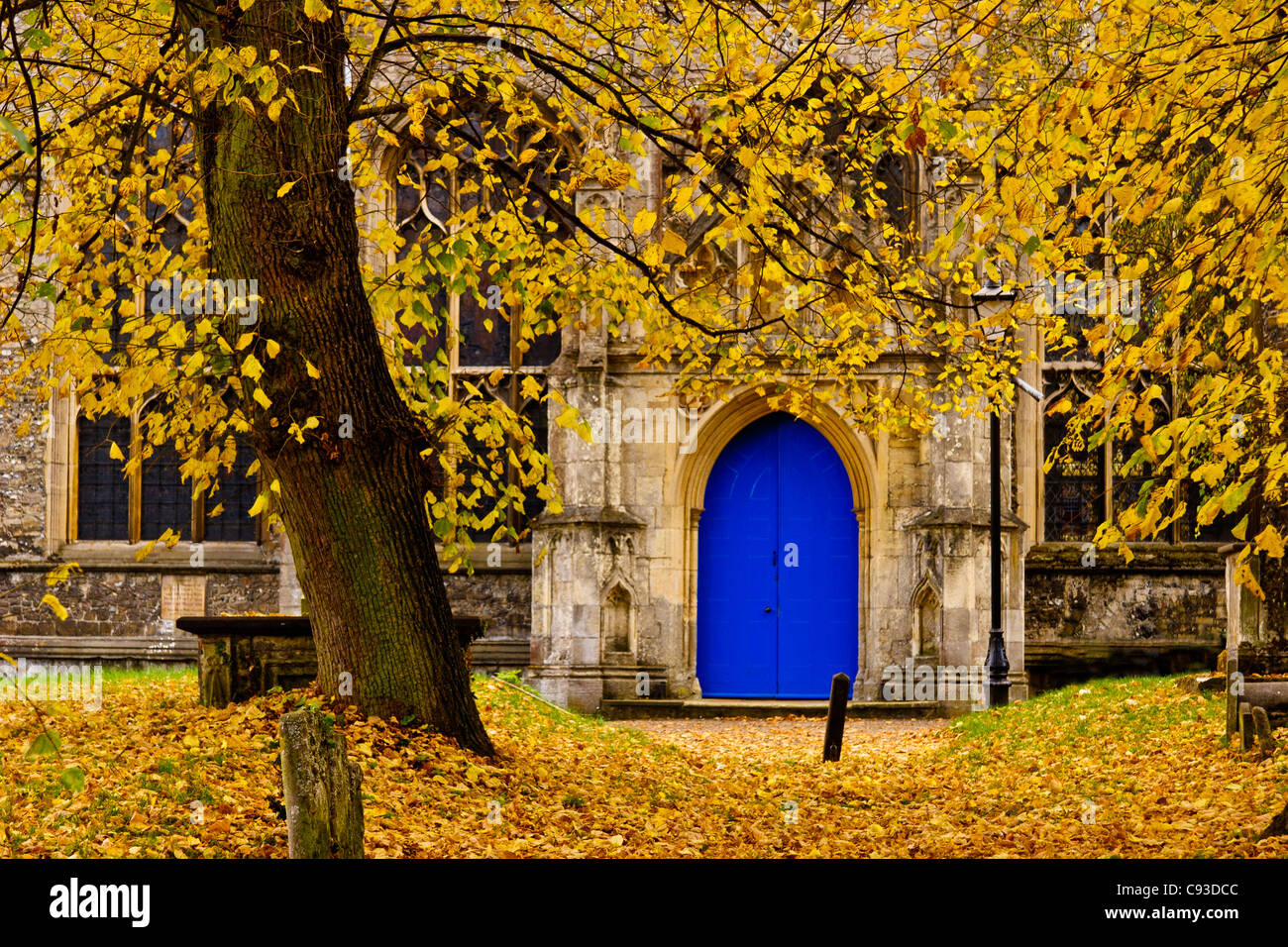 Churchyard and blue church door in Autumn or Fall in Suffolk, England ...