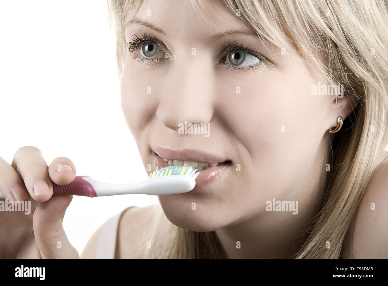 Young beautiful woman clean her teeth Stock Photo - Alamy