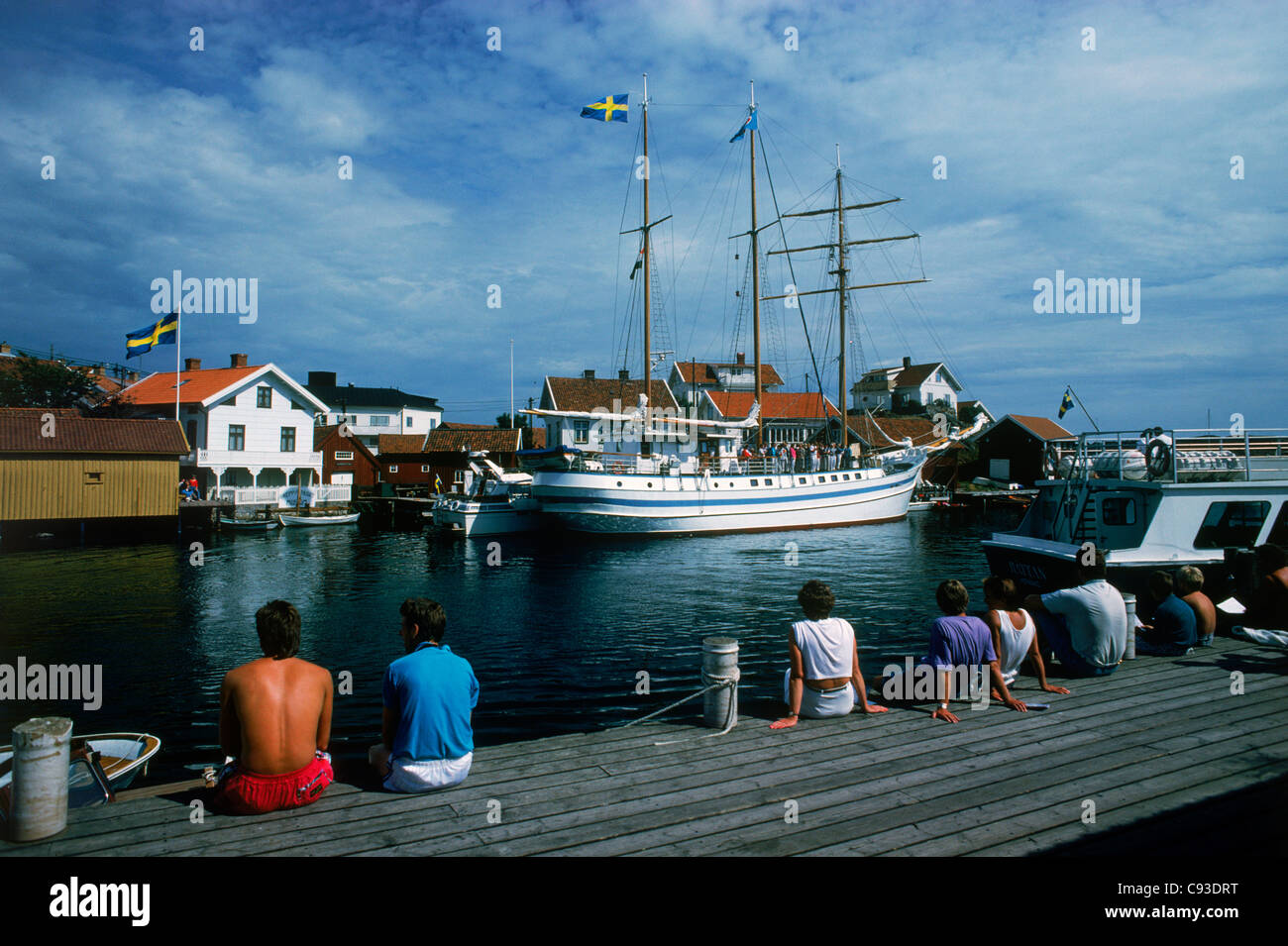 Small harbor with boats and tourists at wooden wharf on island of ...