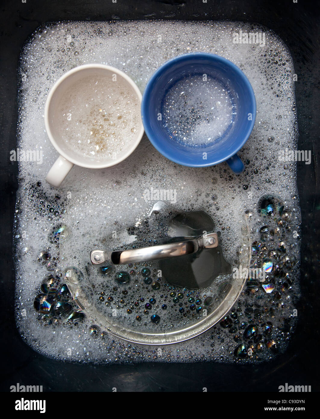 Smile, two mugs and a saucepan lid form the shape of a smiling face in ...
