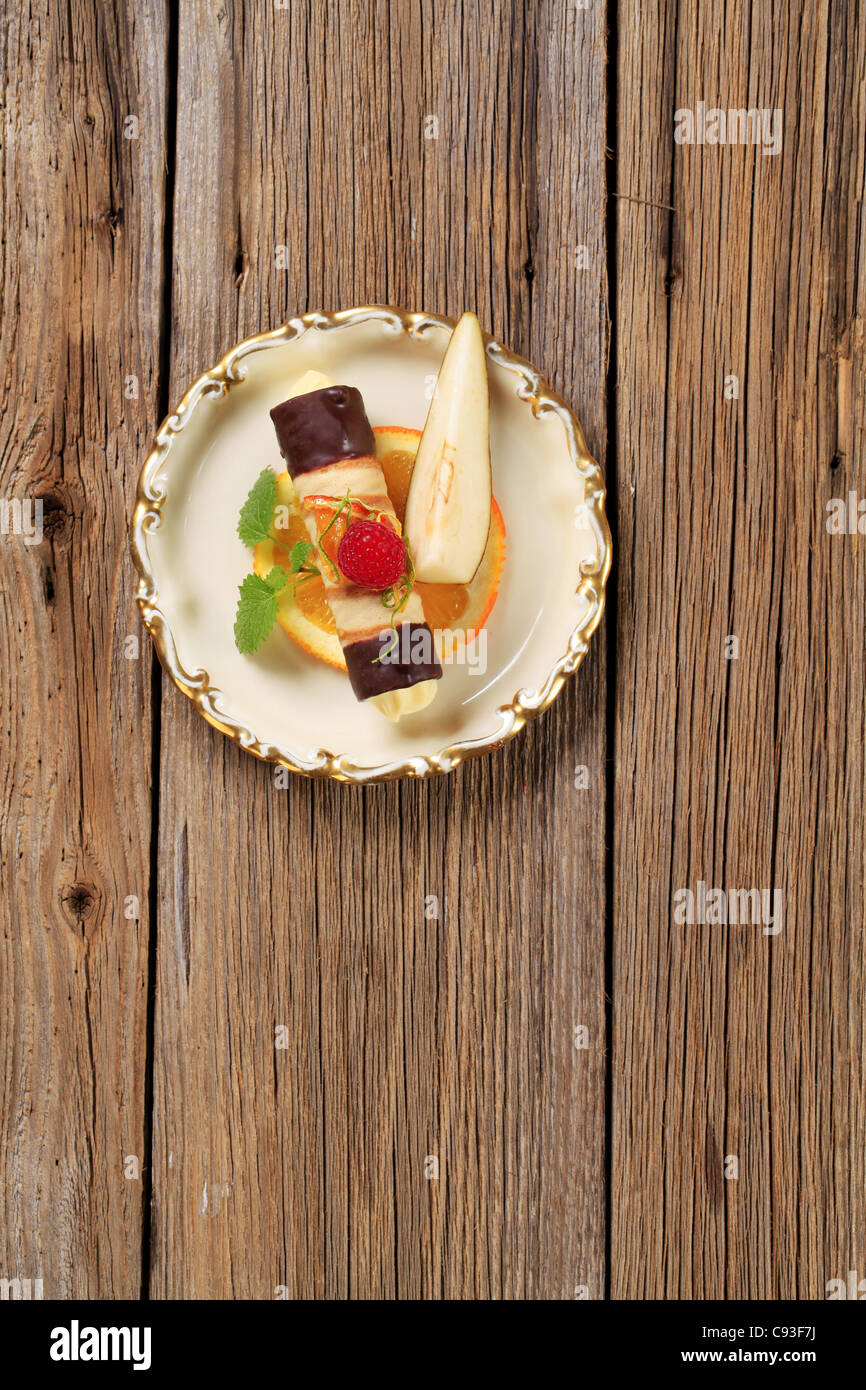 Cream filled wafer roll garnished with fresh fruit Stock Photo - Alamy
