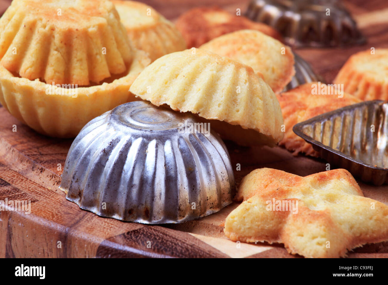 Small tart shells and baking pans on a cutting board Stock Photo - Alamy