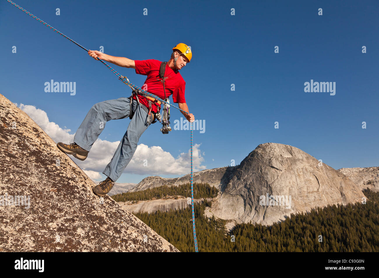 Climber rappelling from the summit after a successful and challenging ...