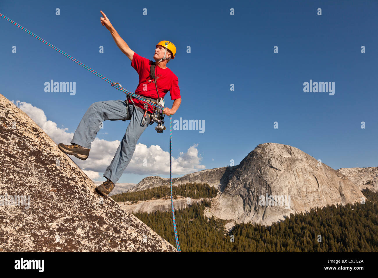Climber rappelling from the summit after a successful and challenging ...