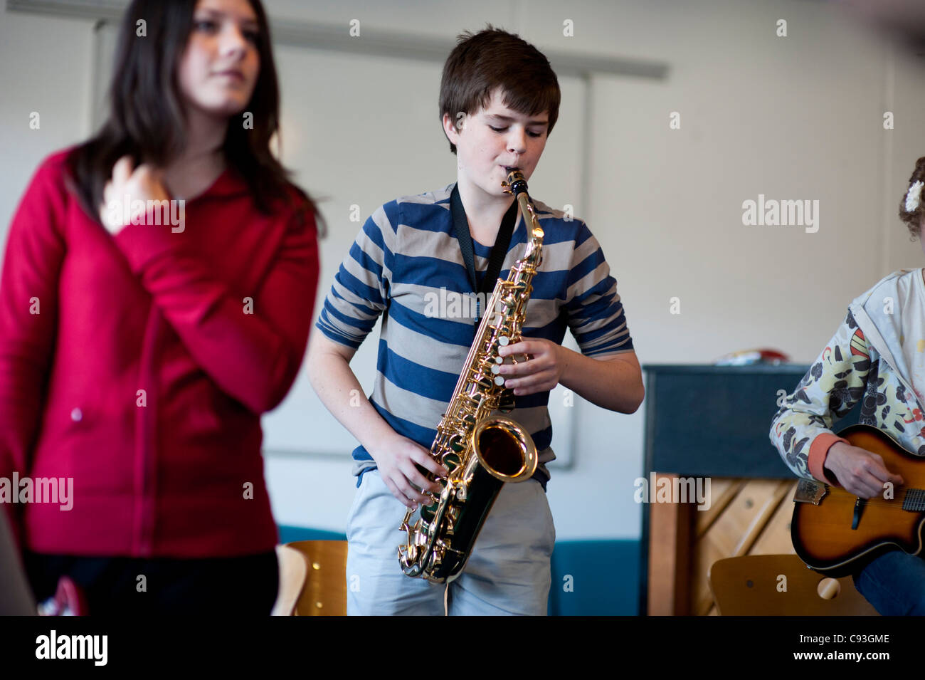 Young boy playing saxophone at a music making workshop class lesson, UK ...