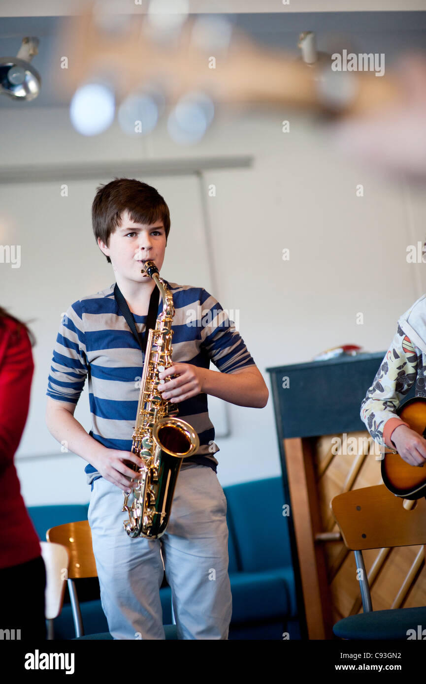 Young boy playing saxophone at a music making workshop class lesson, UK ...