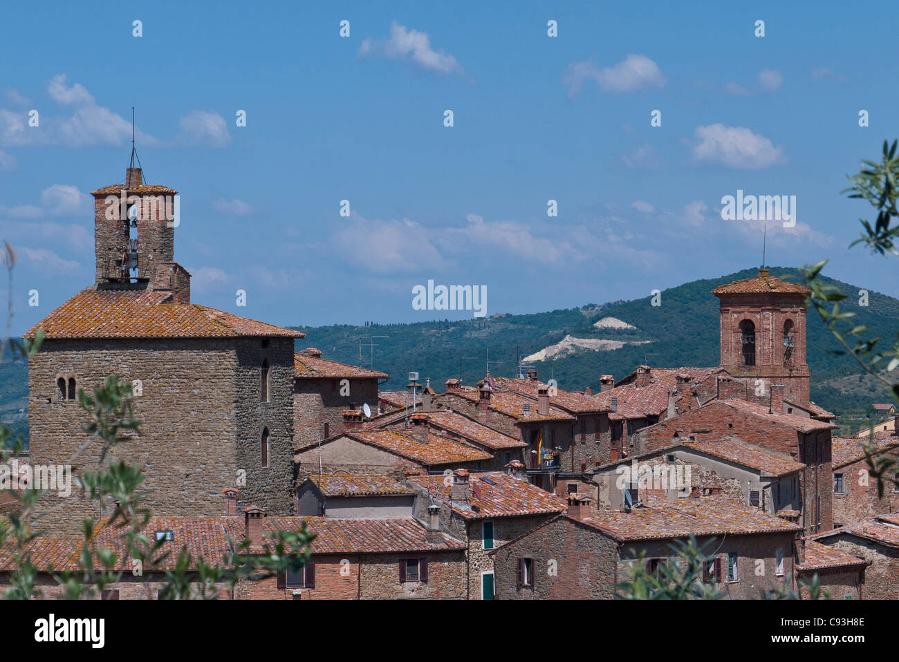 An architectural detail of the red tile roof lines and two towers in ...