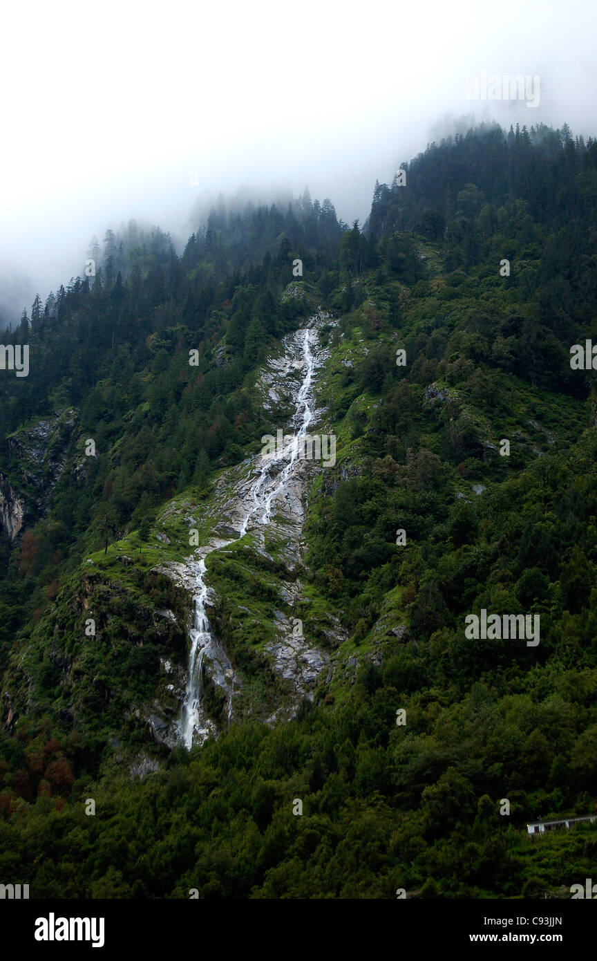 A waterfall flowing down a mountain in the Himalayas Stock Photo - Alamy