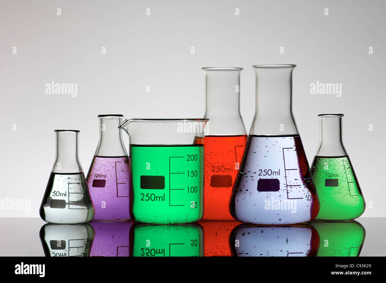 group of laboratory flasks brightly colored liquid Stock Photo - Alamy