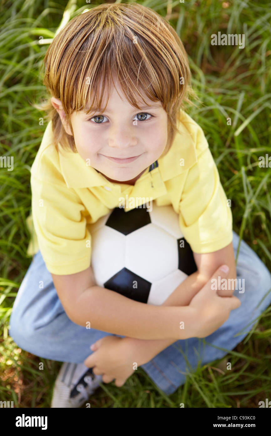 Cross little boy holding football hi-res stock photography and images ...