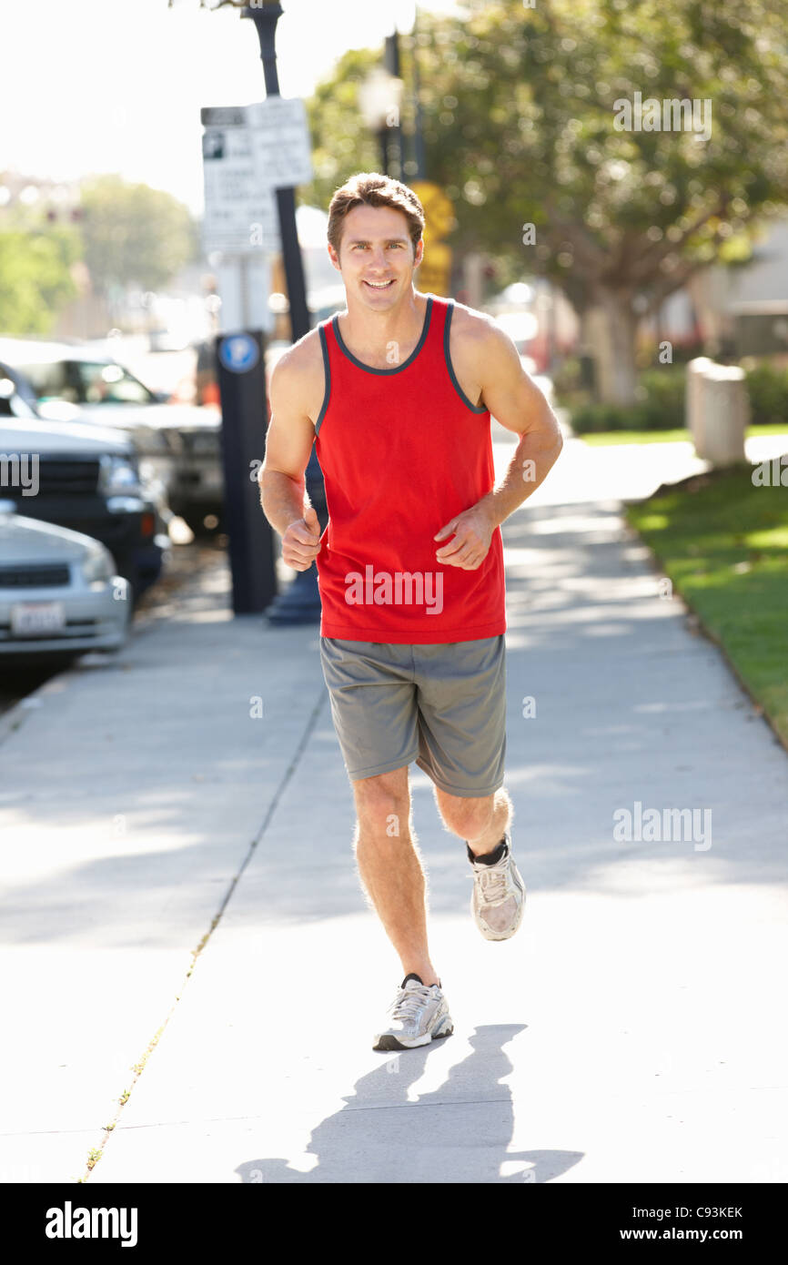 Man running on city street Stock Photo - Alamy