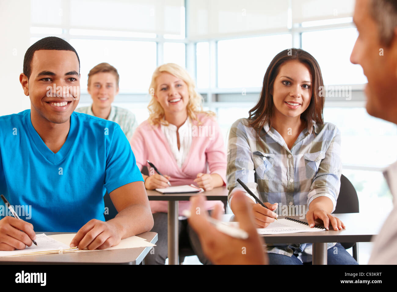 Tutor with class of students Stock Photo - Alamy
