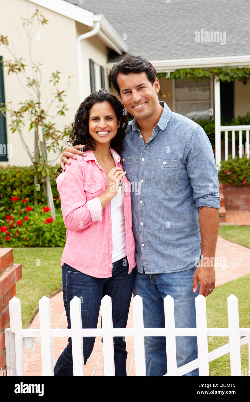 Hispanic couple outside new home Stock Photo - Alamy