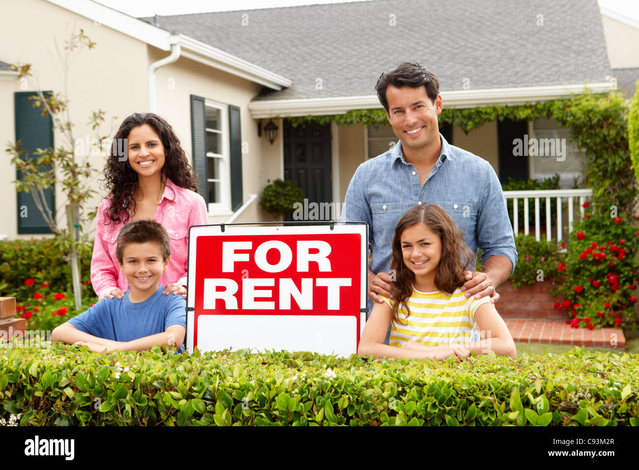 Hispanic family outside home for rent Stock Photo - Alamy