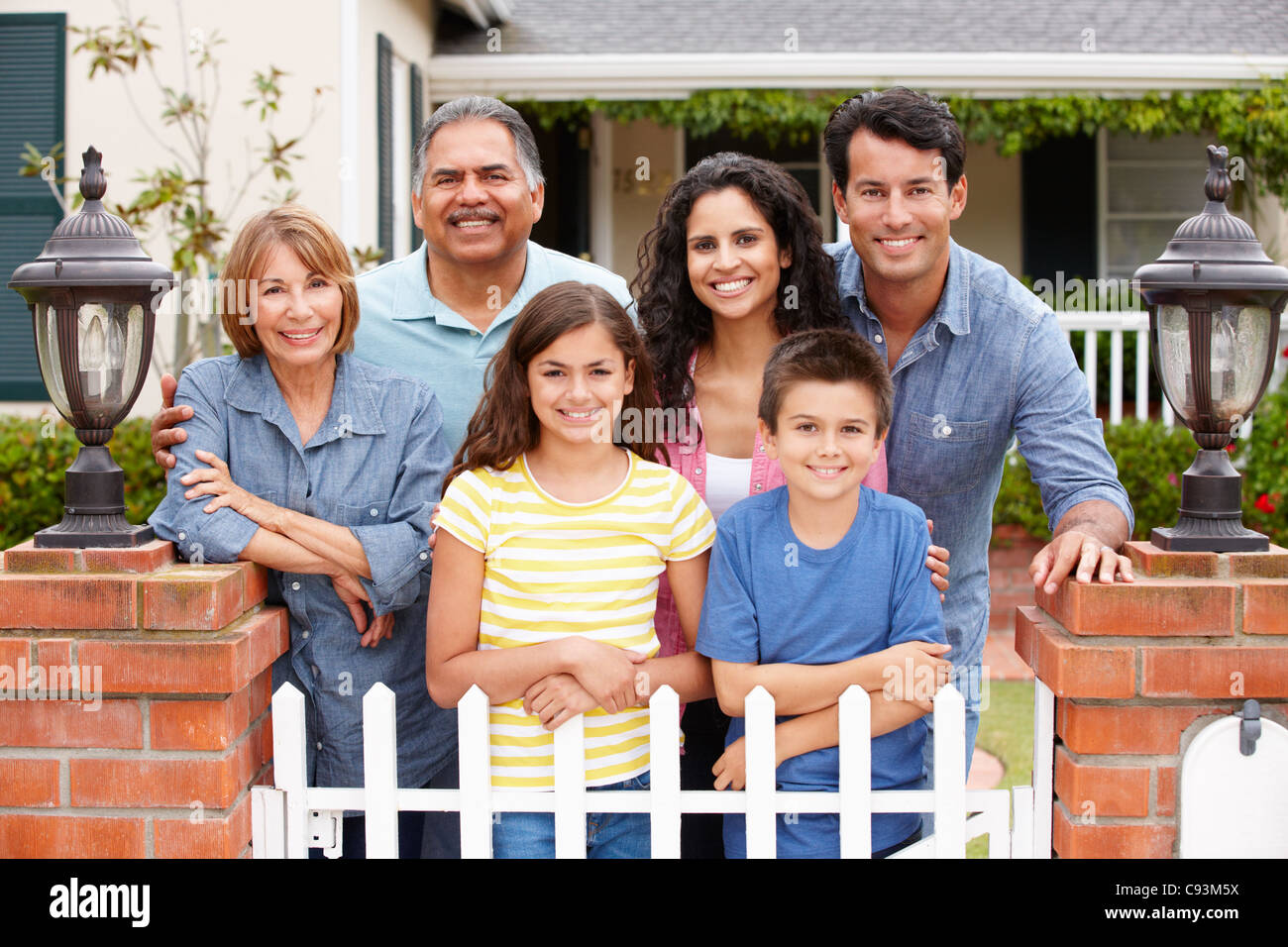 Hispanic family outside home Stock Photo - Alamy