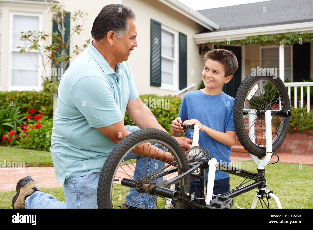boy and grandfather fixing bike Stock Photo - Alamy
