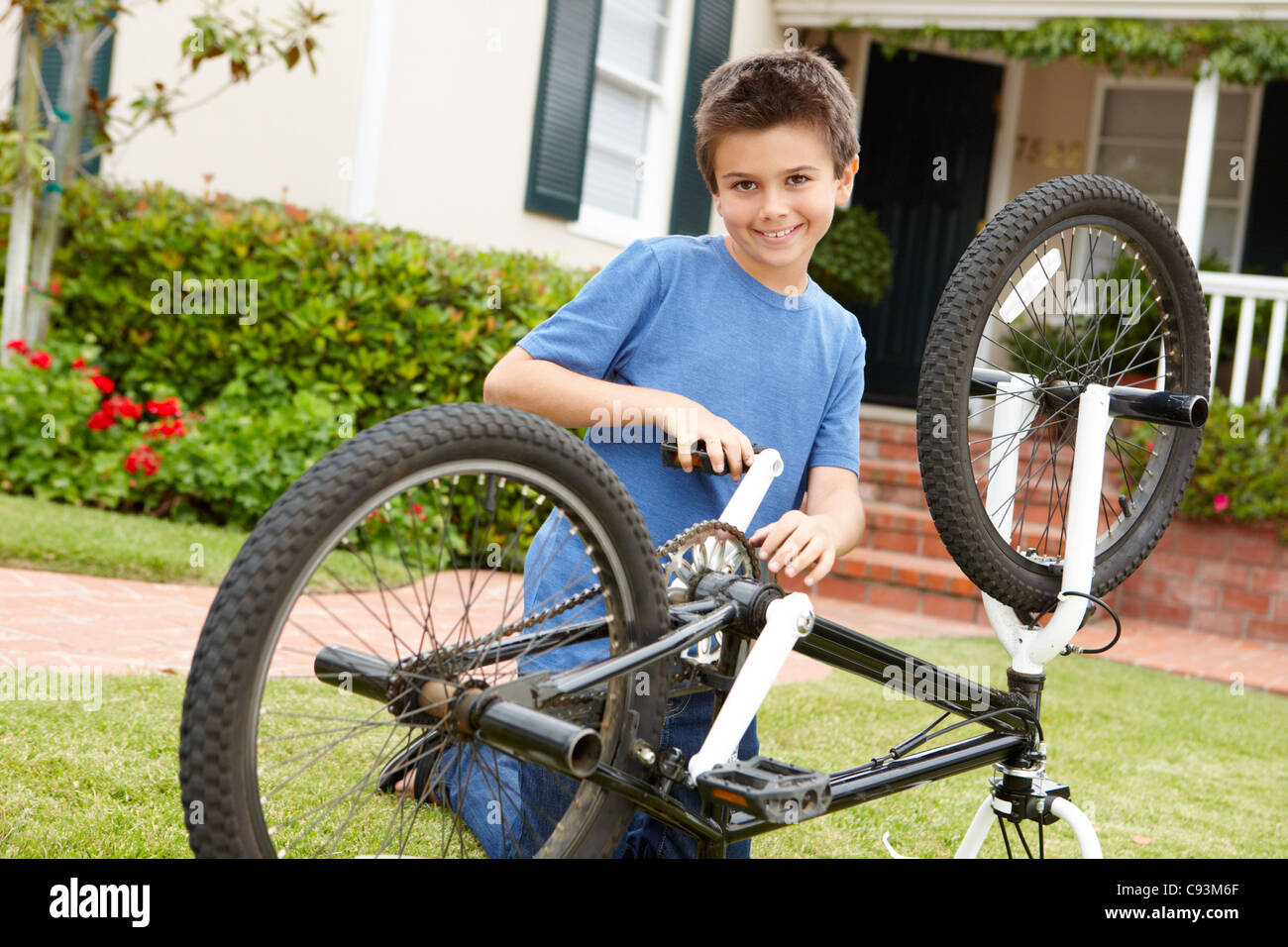 boy fixing bike in garden Stock Photo - Alamy
