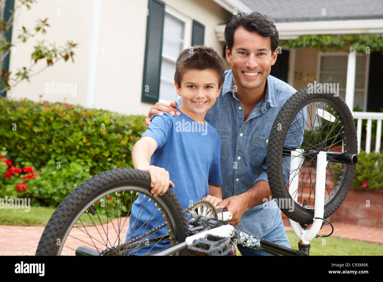 Father and son fixing bike Stock Photo - Alamy