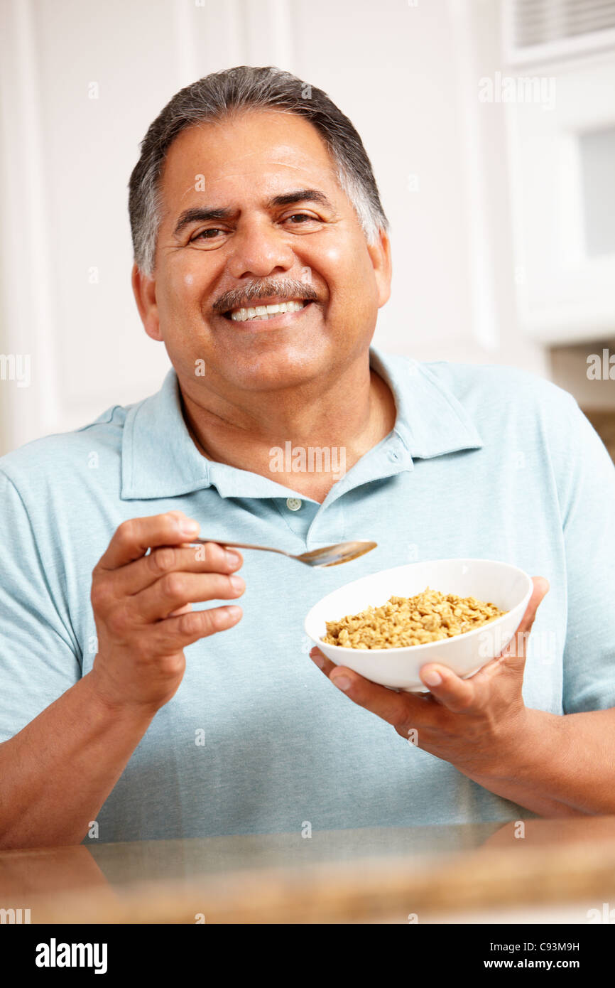 Senior man eating cereal Stock Photo - Alamy