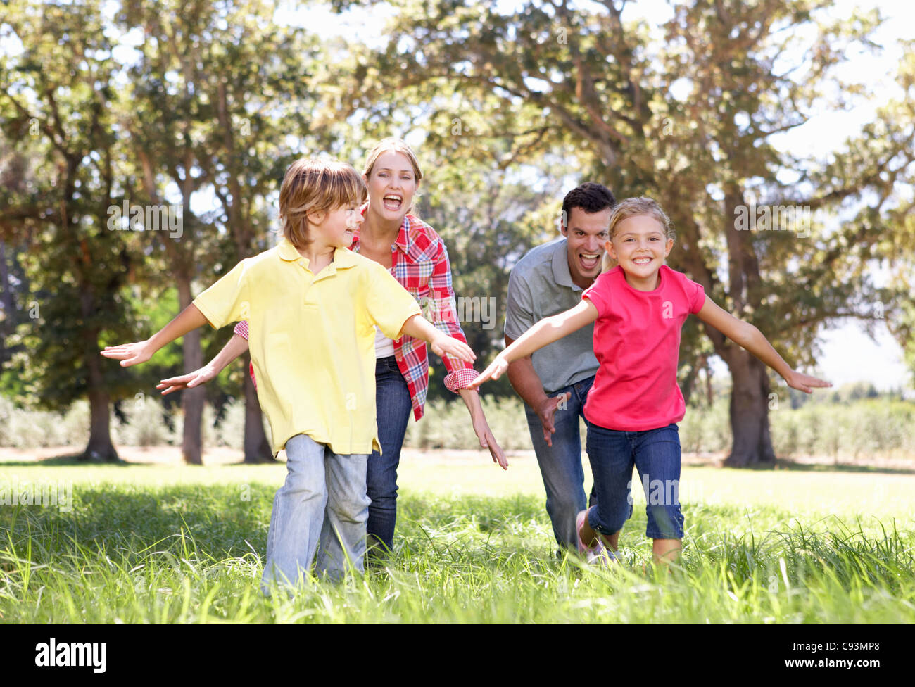 Parents playing with children in country Stock Photo - Alamy