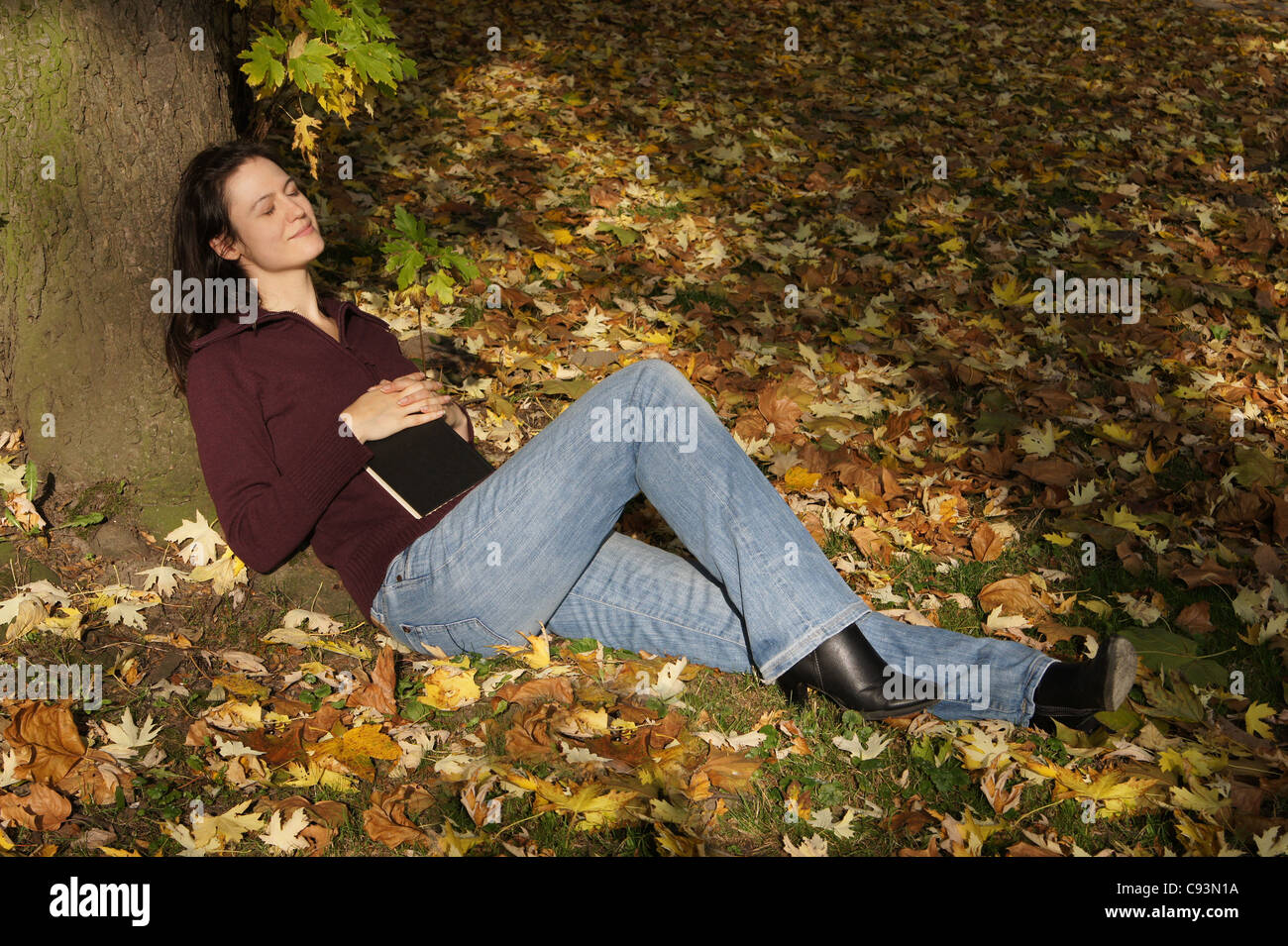 Woman sleeping under tree hi-res stock photography and images - Alamy