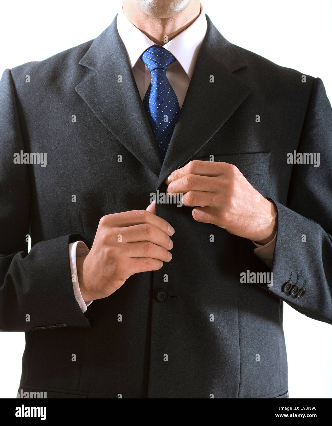businessman buttons up the button on the suit Stock Photo - Alamy