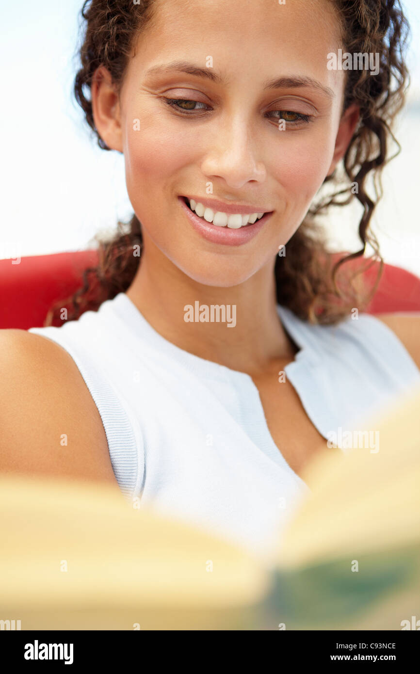 Young woman reading book Stock Photo - Alamy